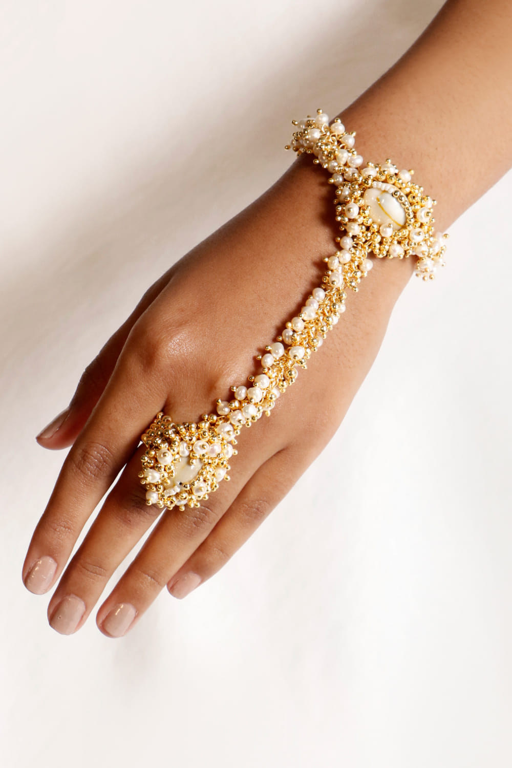 Buy Gold pearl shell hathphool by Vaidaan at Aashni and Co